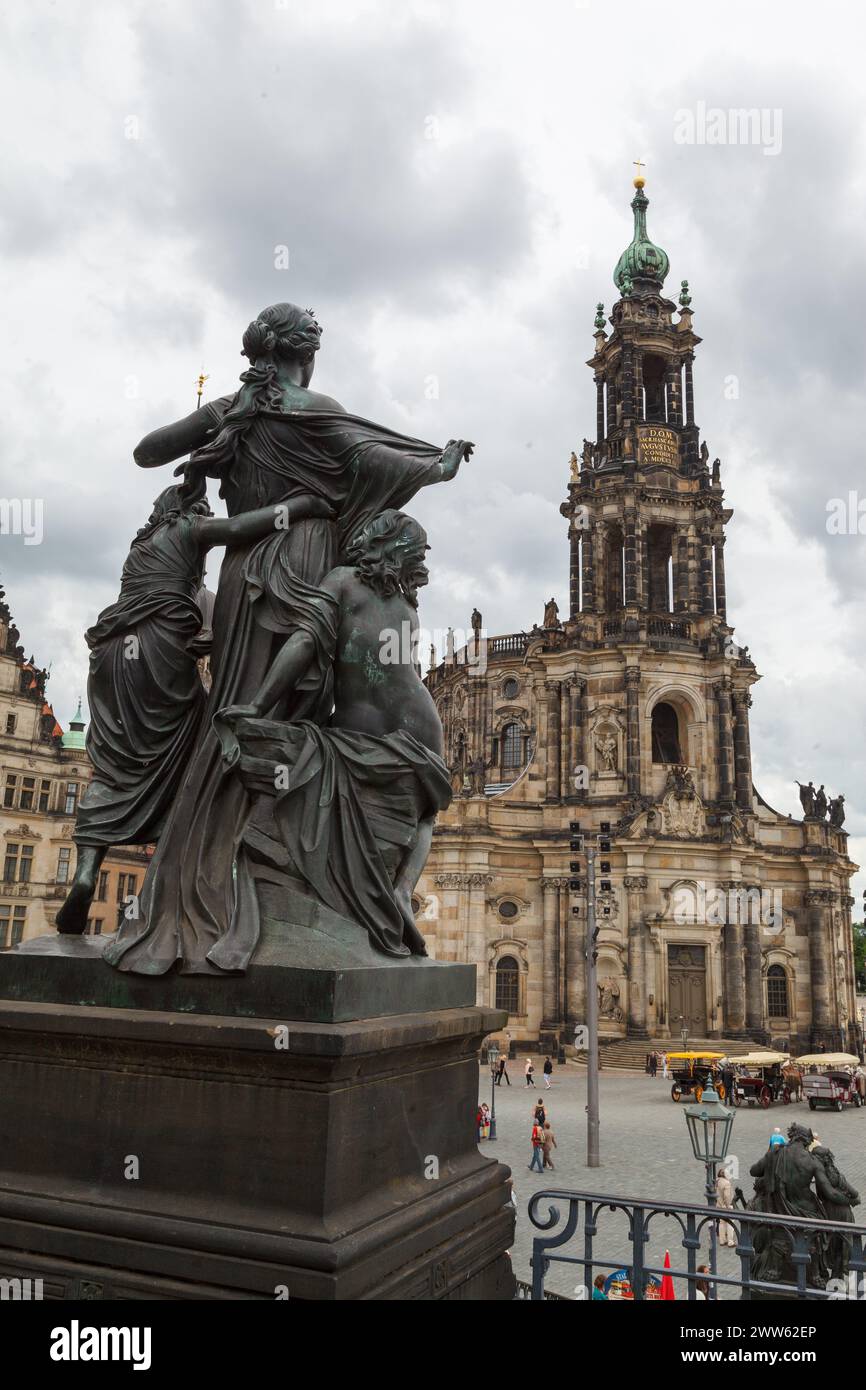 A bronze statue and the facade of the historical building Hofkirche ...