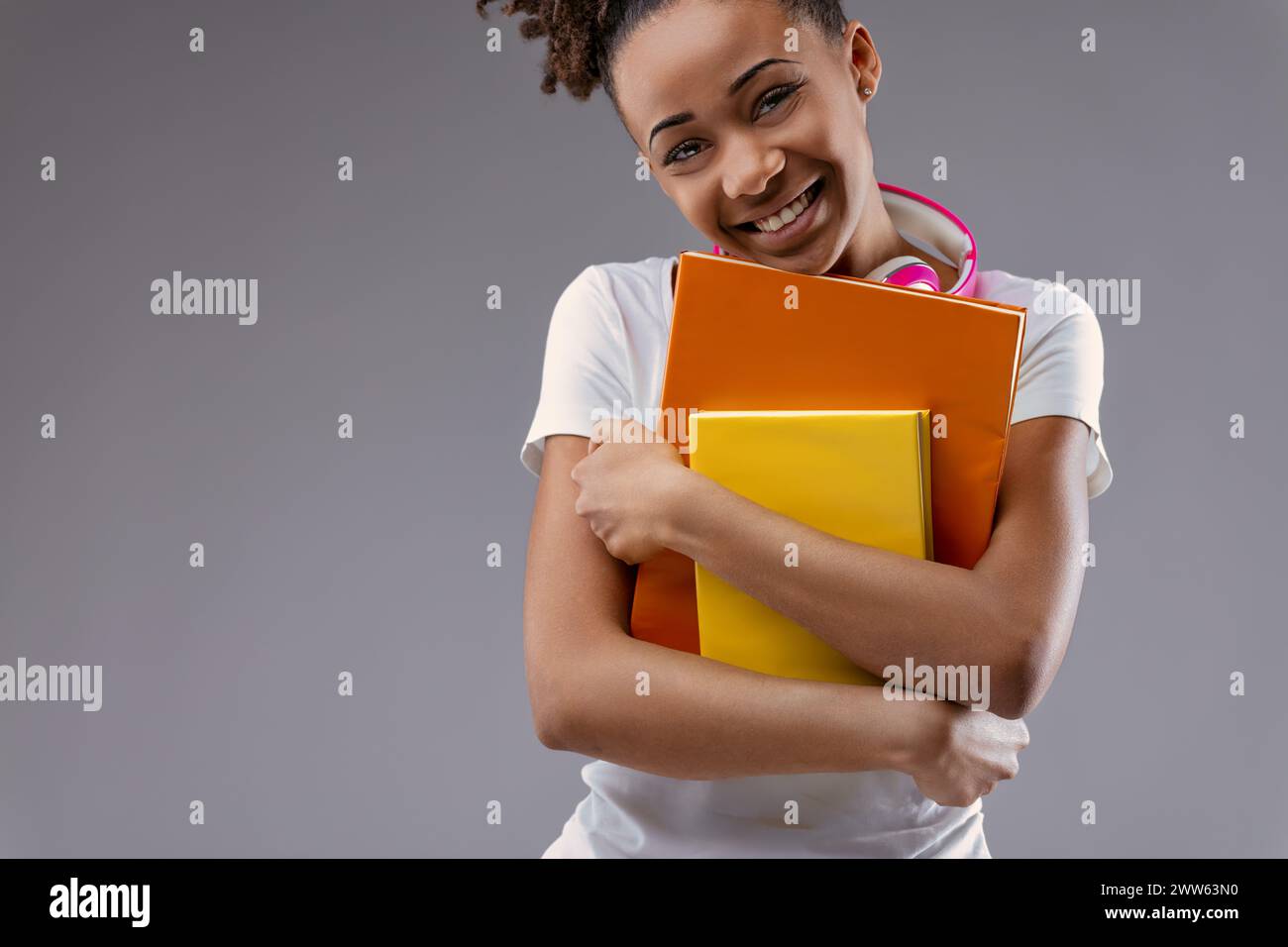 Hugging her books close, she represents the bright future of empowered ...