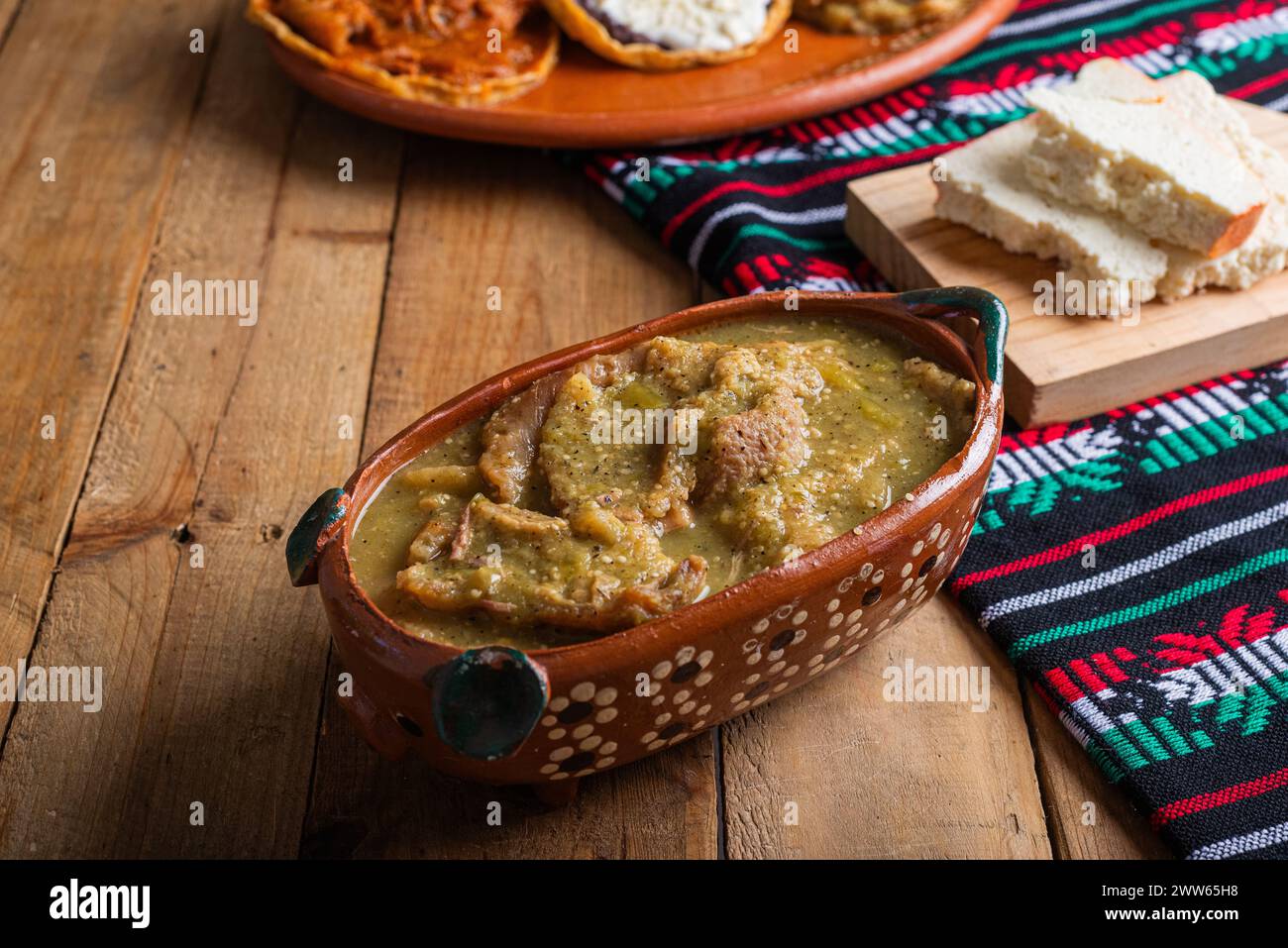 Chicharrones in green sauce, typical mexican food. Mexican food in clay ...