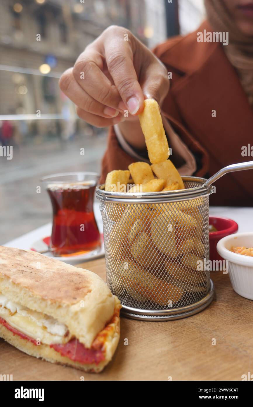women hand pick french fries Stock Photo - Alamy