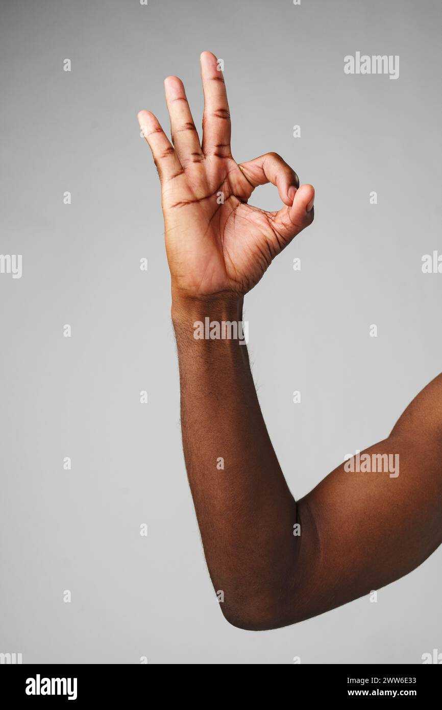 Human Hand Gesturing Three Fingers Up Against a Neutral Grey Background ...