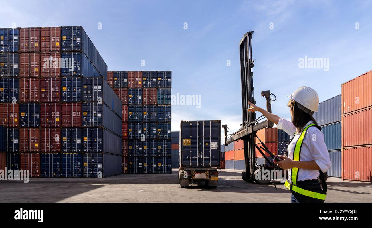 Foreman Woman control loading Containers box from Cargo freight ship ...
