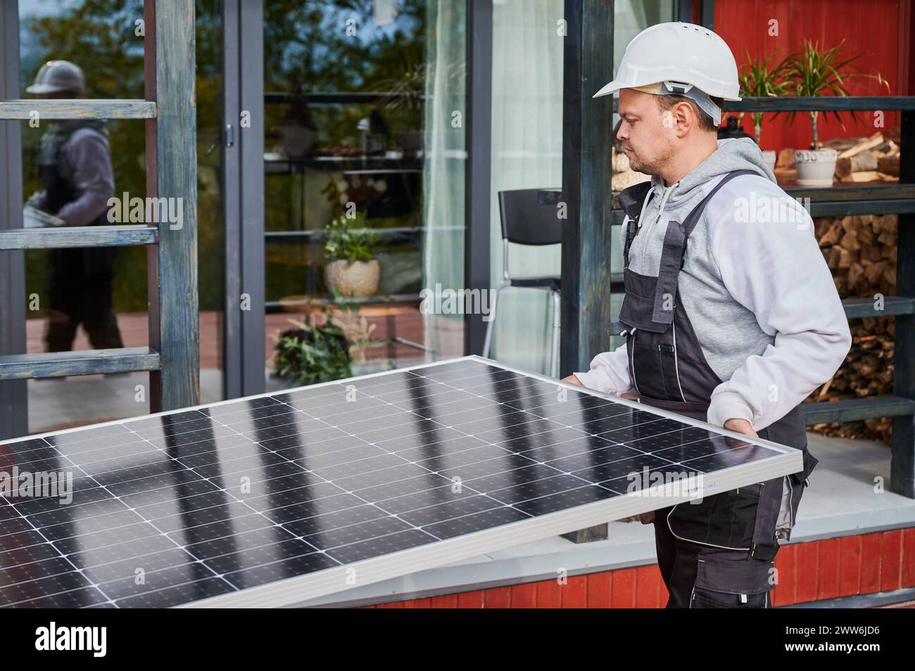 Technicians building solar panel system. Men workers in helmets ...