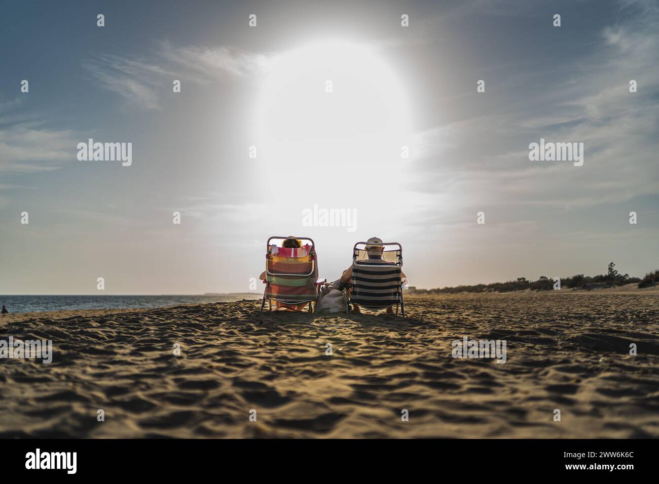 Couple sunbathing at the beach hi-res stock photography and images - Alamy