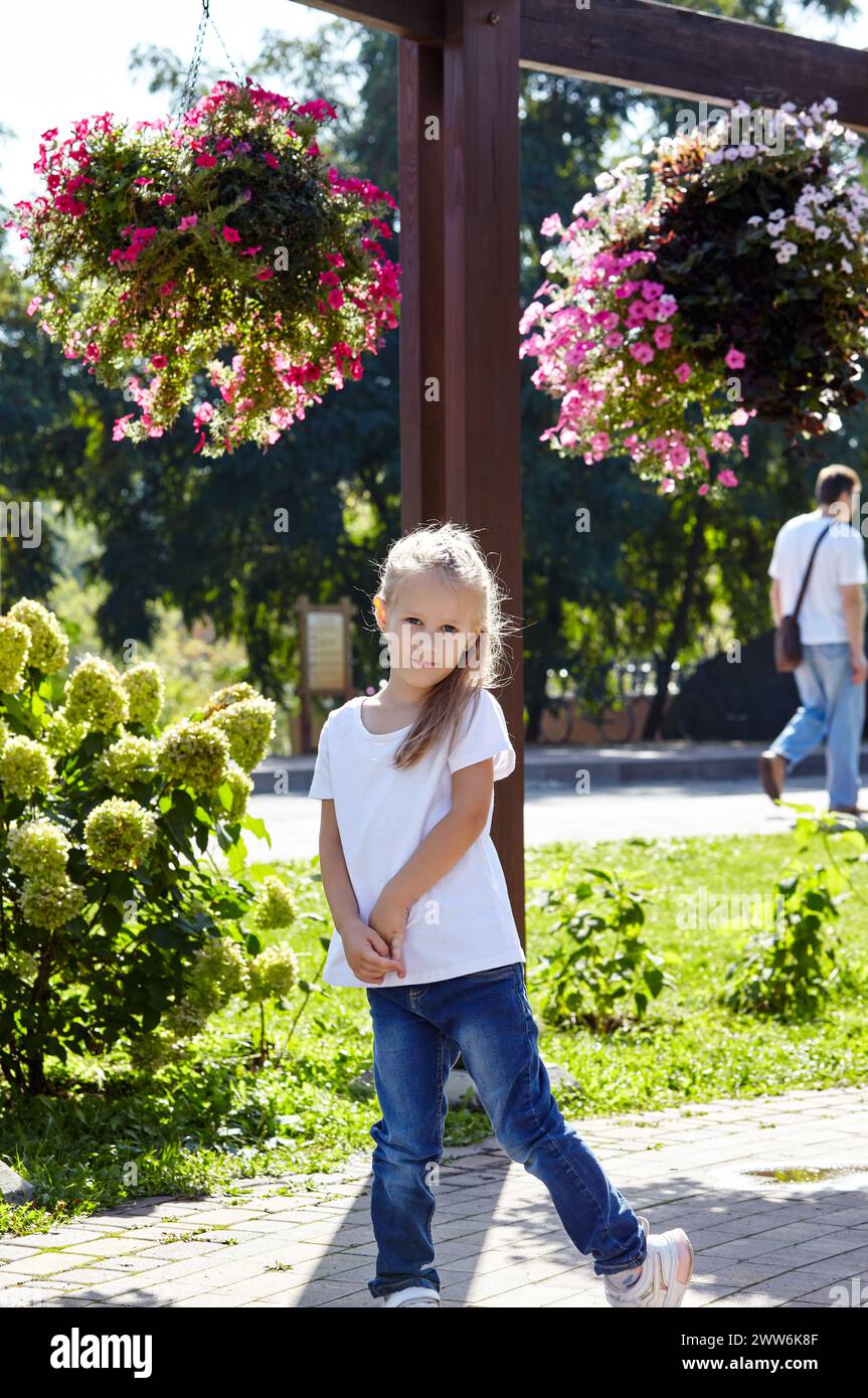 Little girl walk in the summer city park. Childhood, leisure and people ...