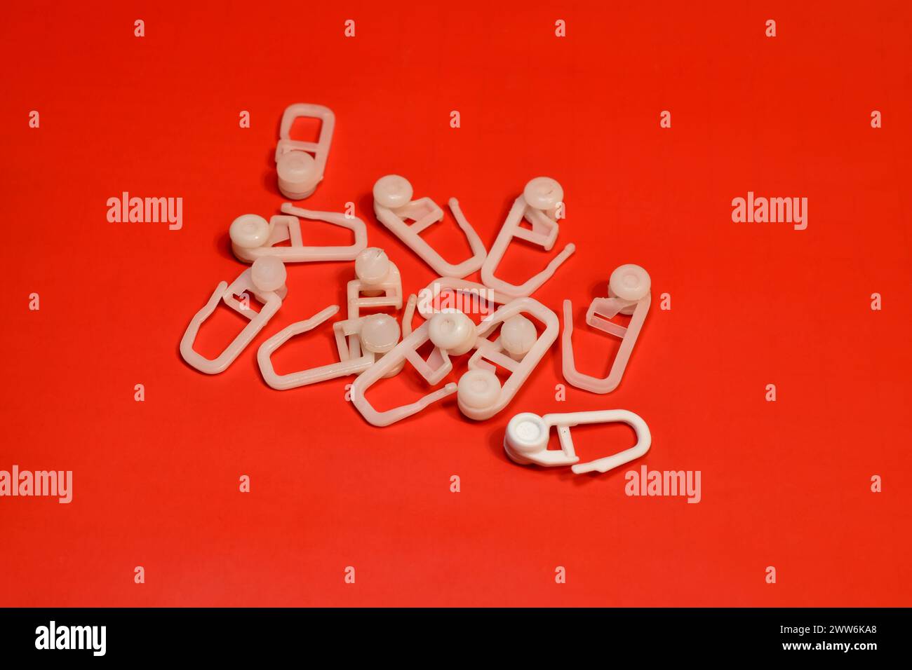 Plastic curtain rod hooks for hanging curtains Stock Photo - Alamy