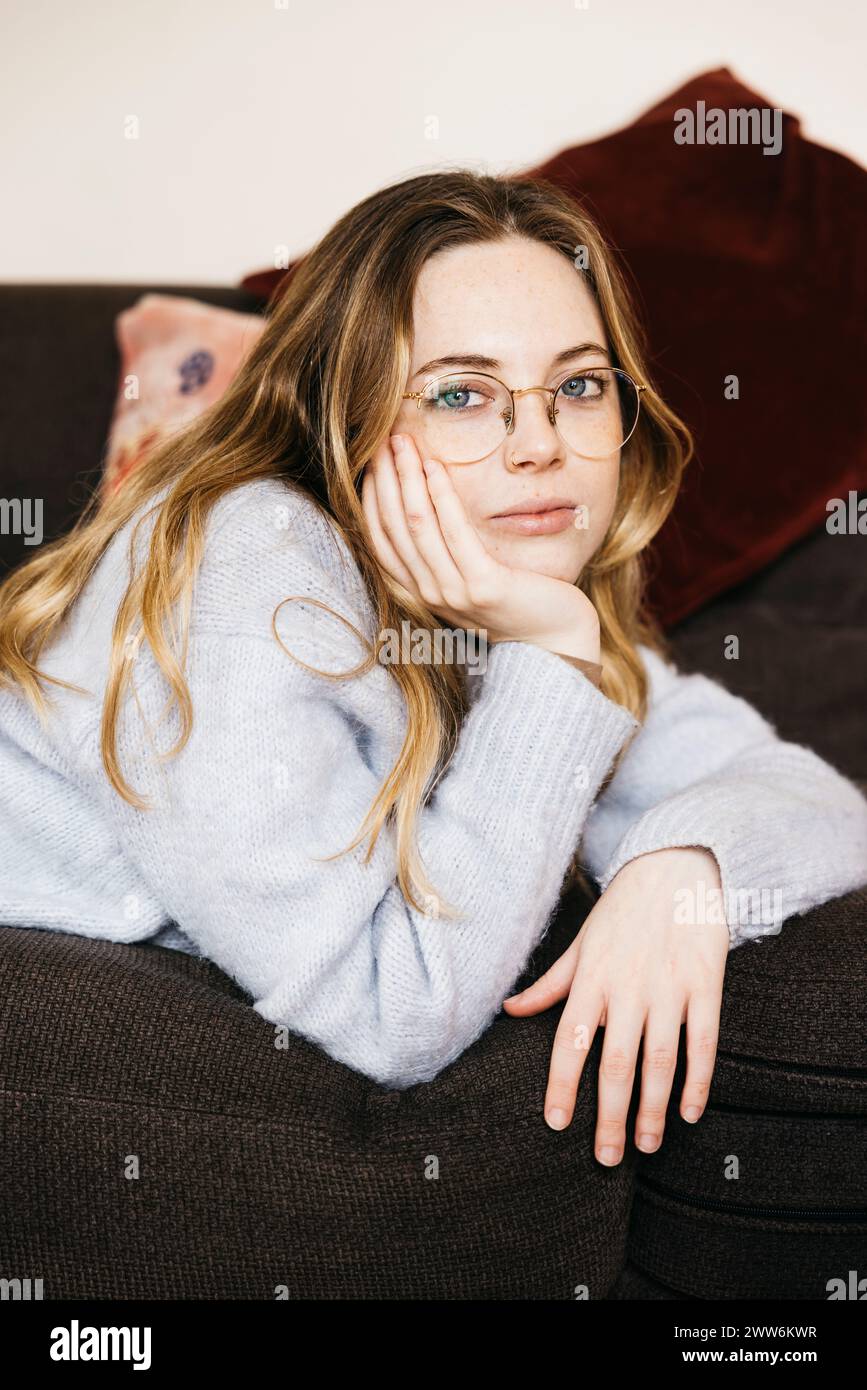 Portrait Of A Young Beautiful Blonde Women With Glasses Lying