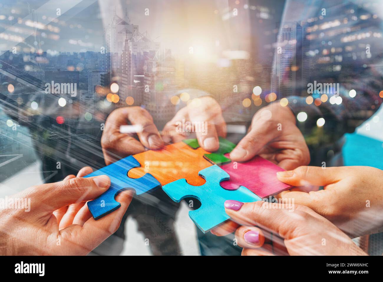 Businessmen working together to build a puzzle as teamwork, partnership ...