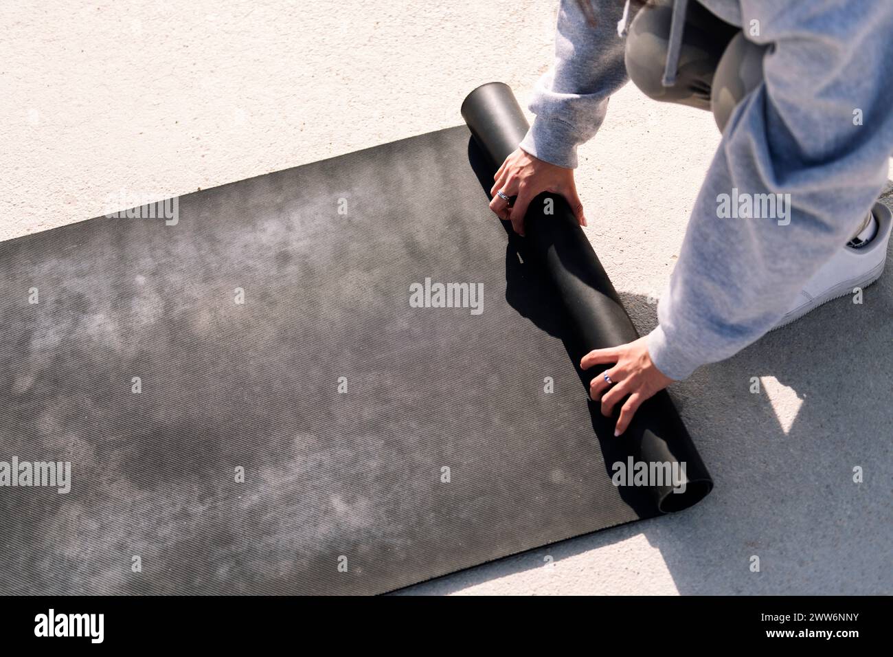 Woman unrolling exercise mat hi-res stock photography and images - Alamy