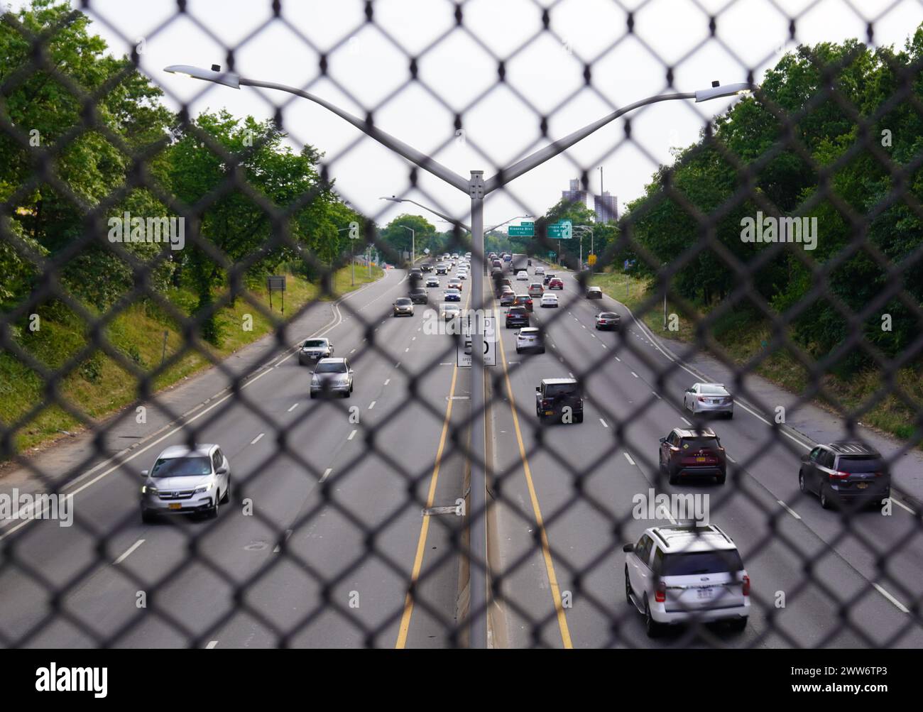 A highway with traffic seen from a bridge with a fence Stock Photo - Alamy