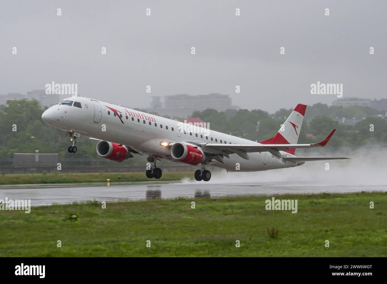 Austrian Airlines Embraer E195 aircraft blasting the rainwater off from ...