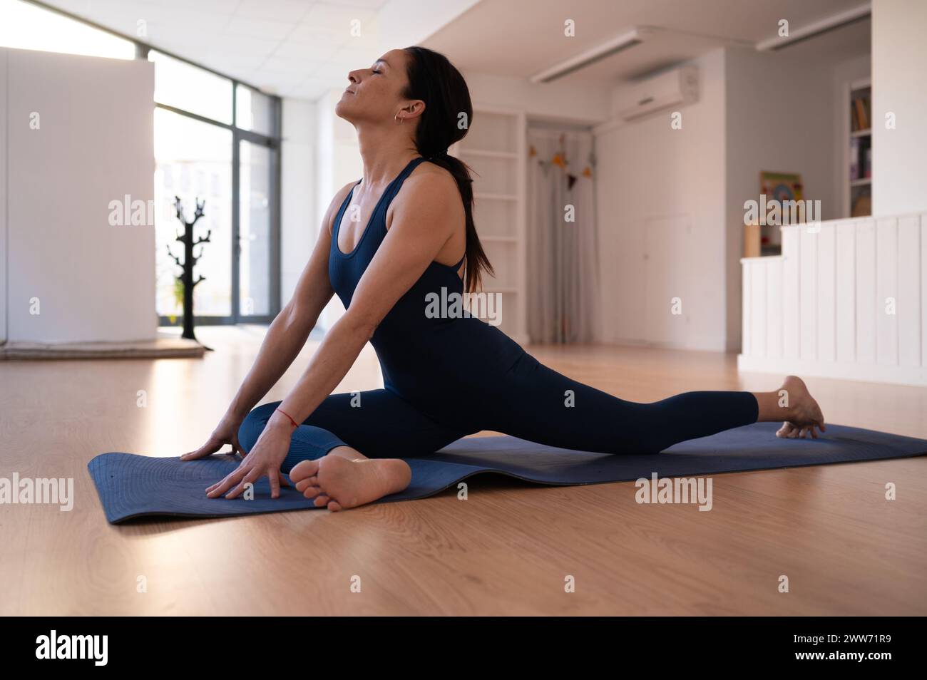Yoga teacher stretching her legs before a class. Yoga concept Stock ...