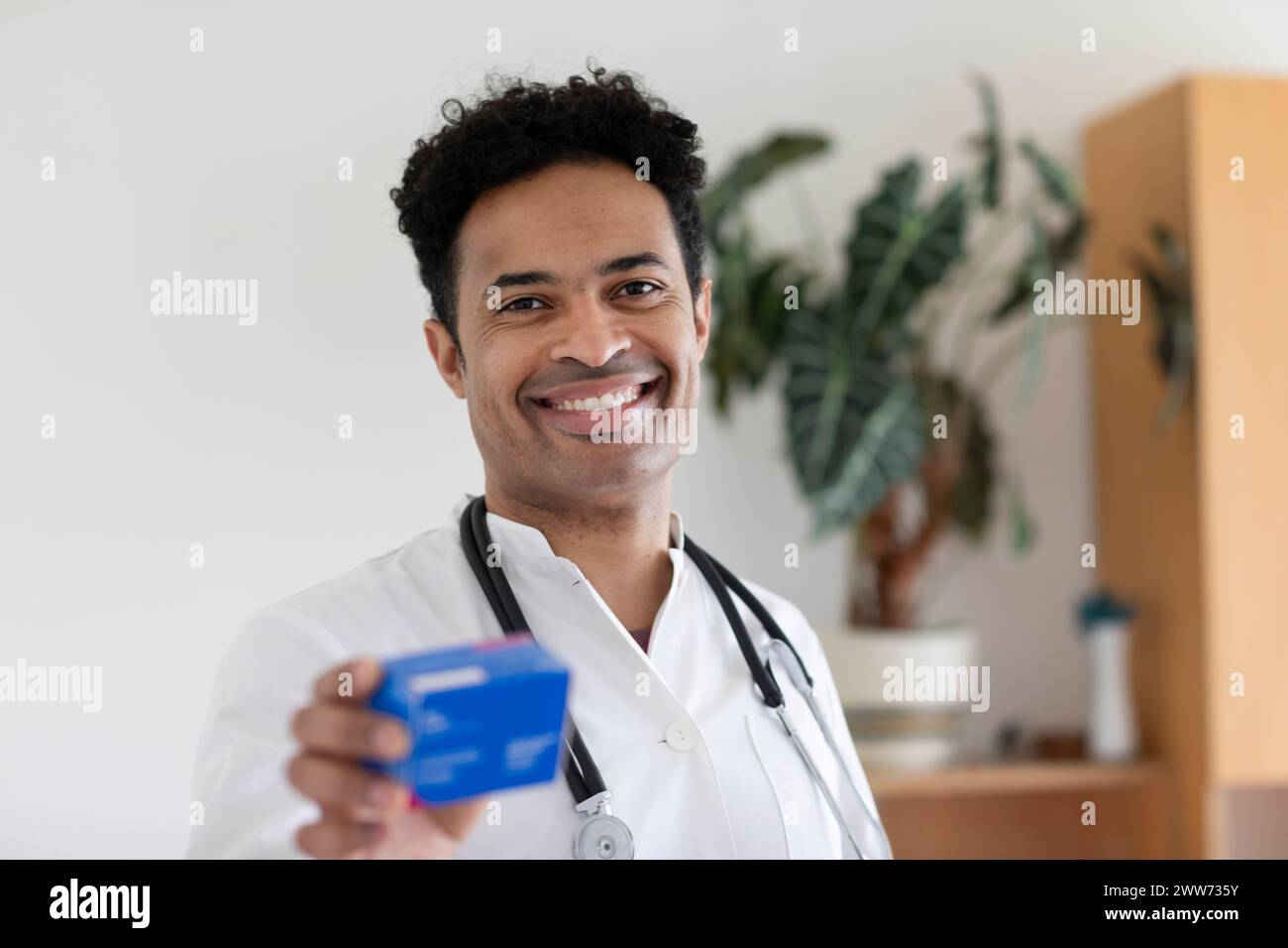 doctor, male, mixed race in a practice Stock Photo - Alamy