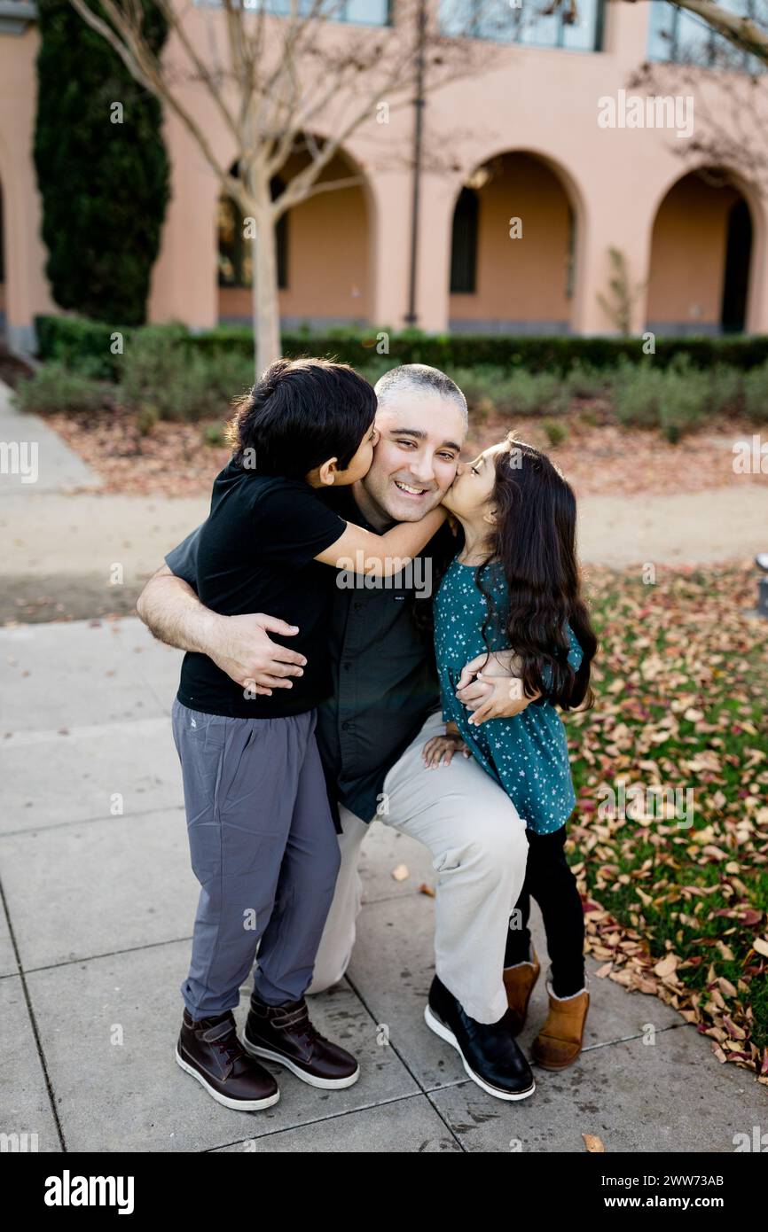 Dad Getting Kisses From Daughter & Autistic Son in San Diego Stock ...