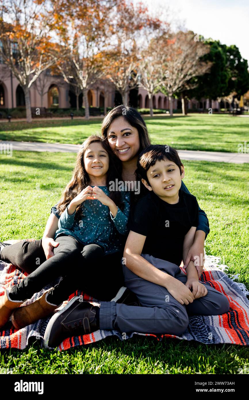Mother of Two Sitting in Park with Daughter & Autistic Son Stock Photo ...