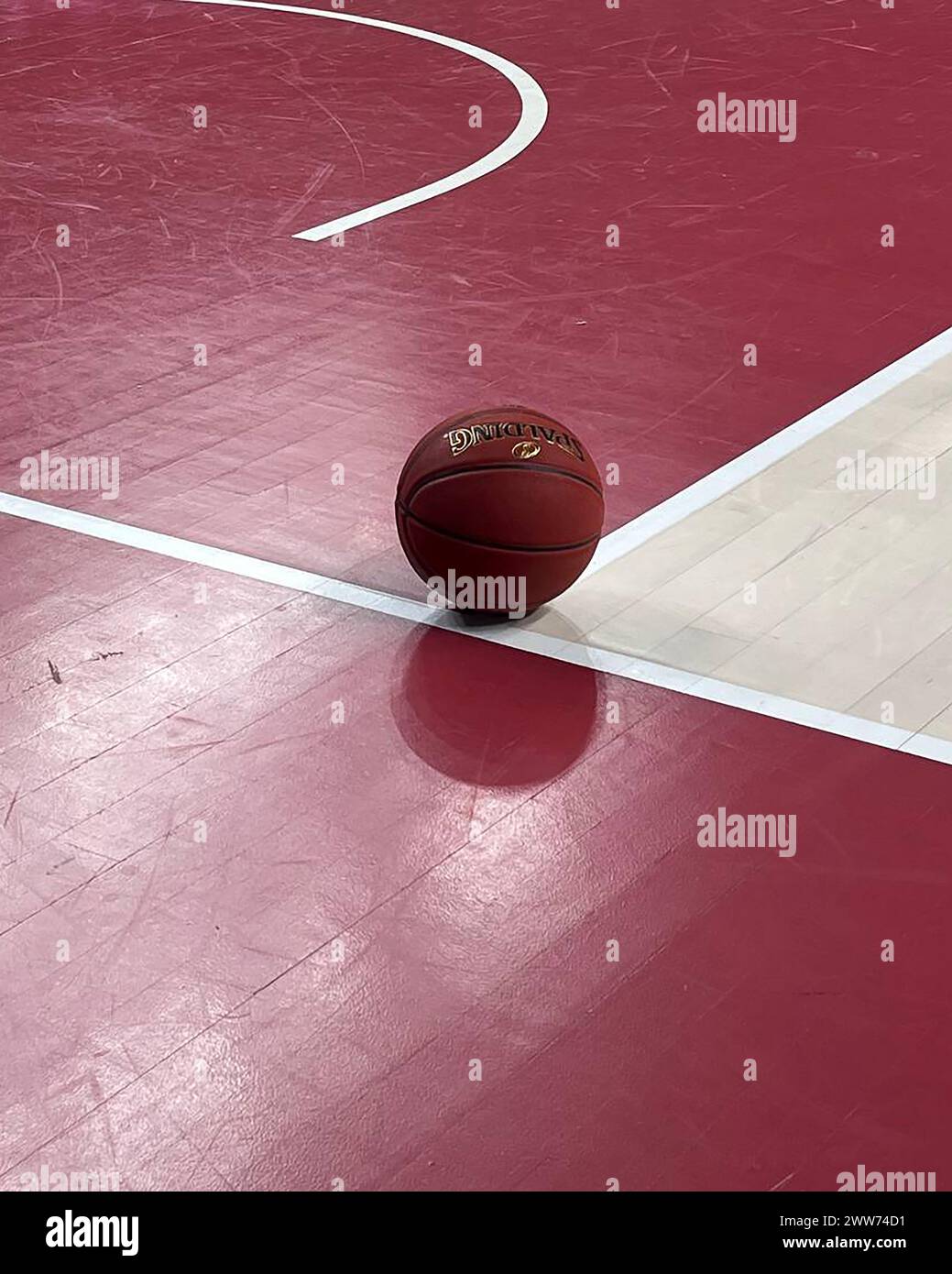 brown leather basketball on red court Stock Photo - Alamy
