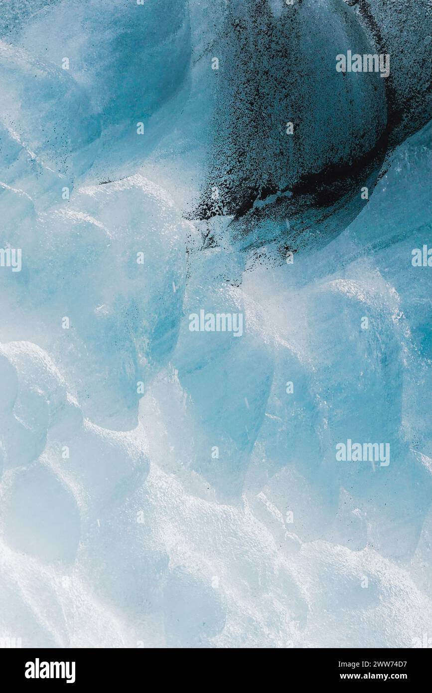 Textured wall of ice inside a glacier covered in black ash Stock Photo ...