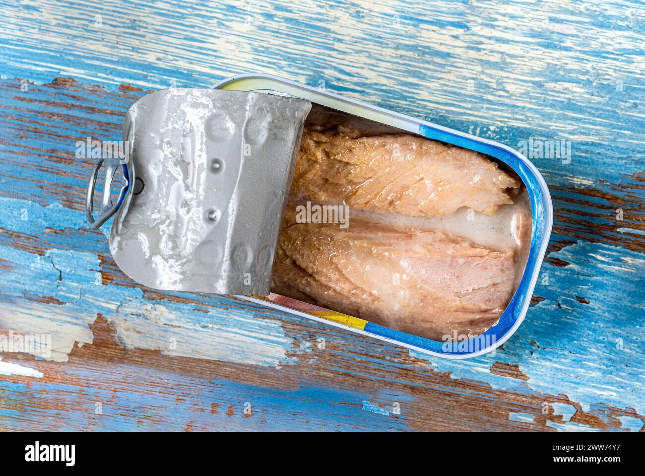 Open tuna can close up top view on blue stained background Stock Photo ...