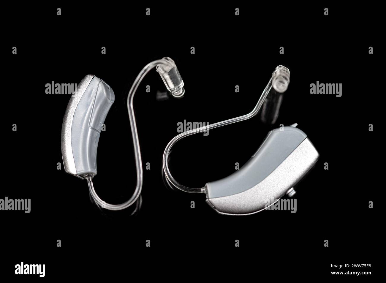 Close-up of two earbuds viewed from above on black background Stock ...