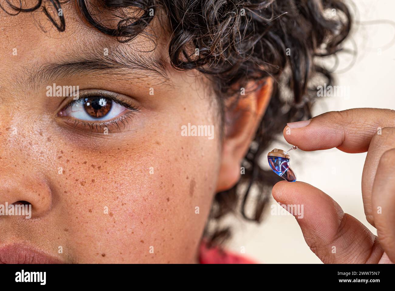 Teenager preparing to attach a prosthesis in the ear Stock Photo - Alamy