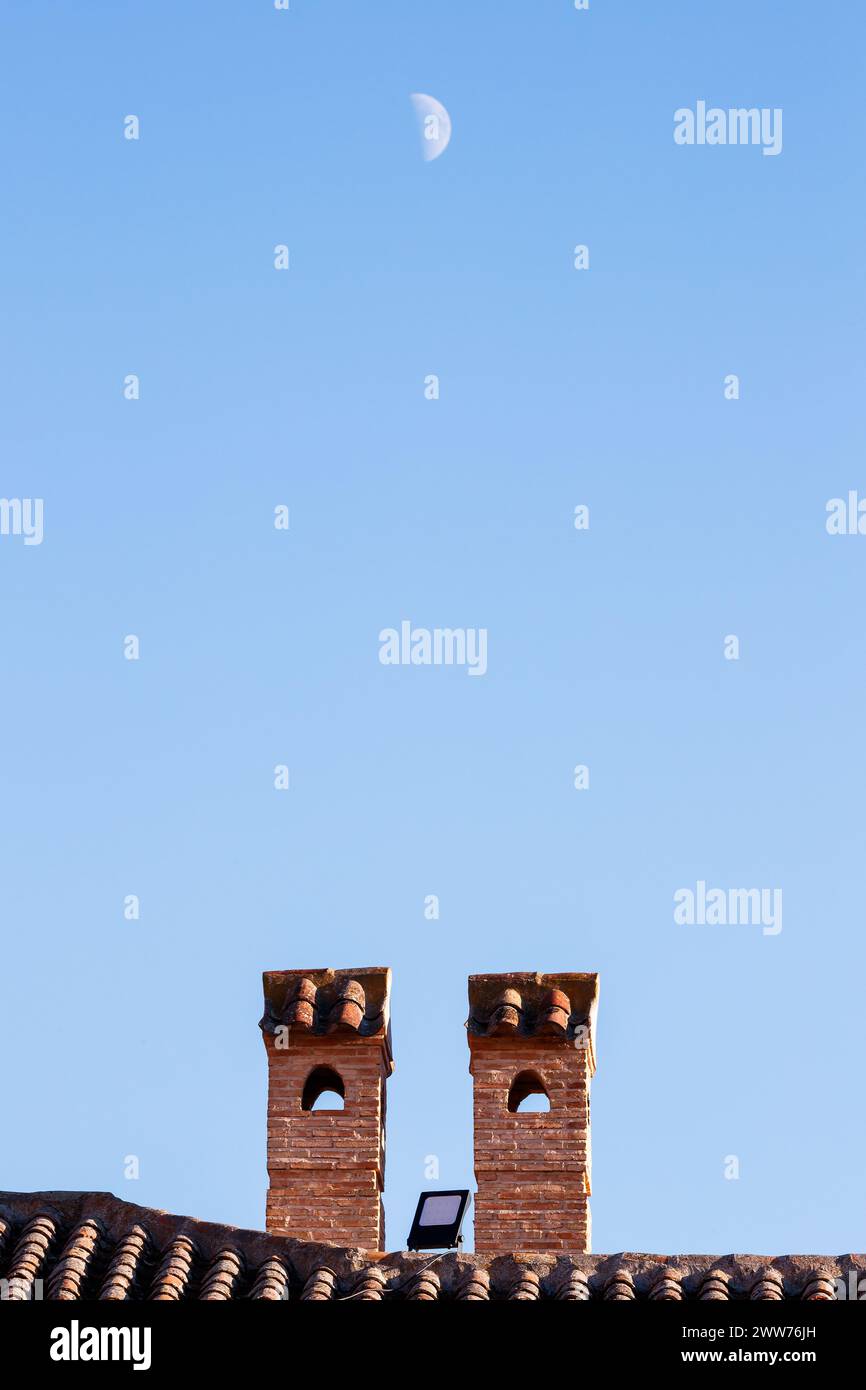 Two chimneys with the moon Stock Photo - Alamy