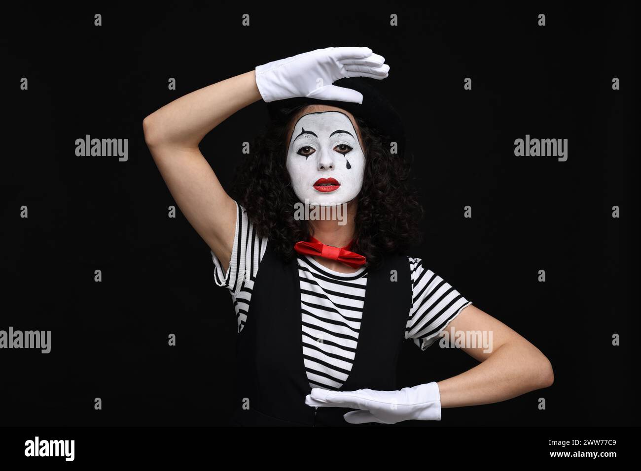 Young woman in mime costume posing on black background Stock Photo - Alamy