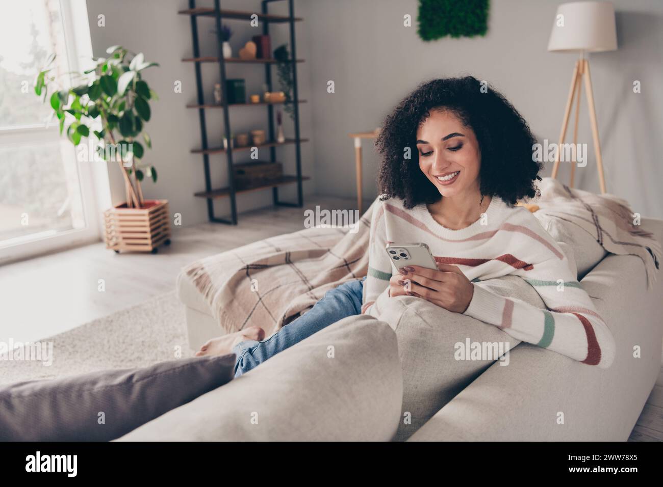 Photo of positive cute lady dressed striped pullover communicating ...
