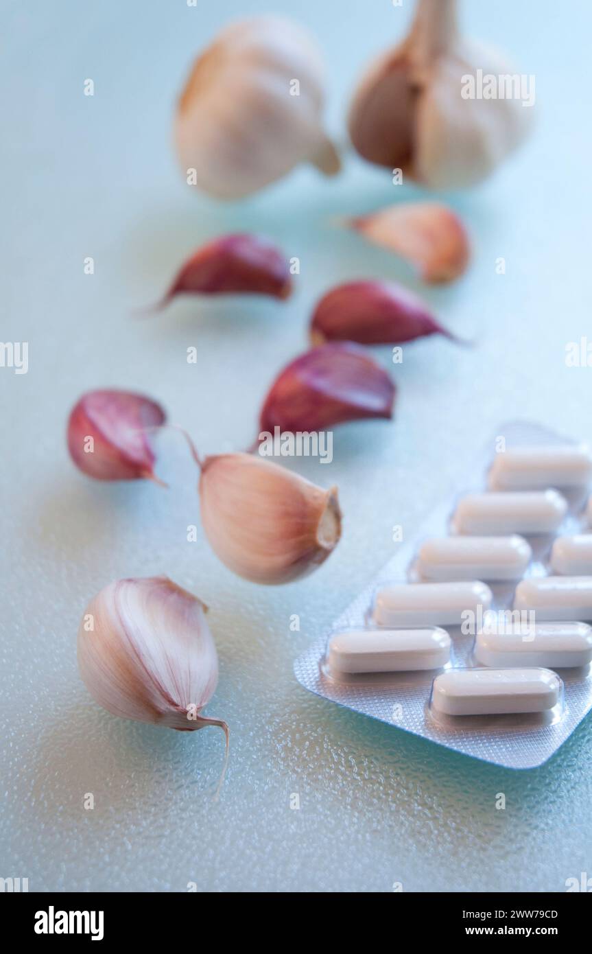 Garlic versus pills Stock Photo - Alamy