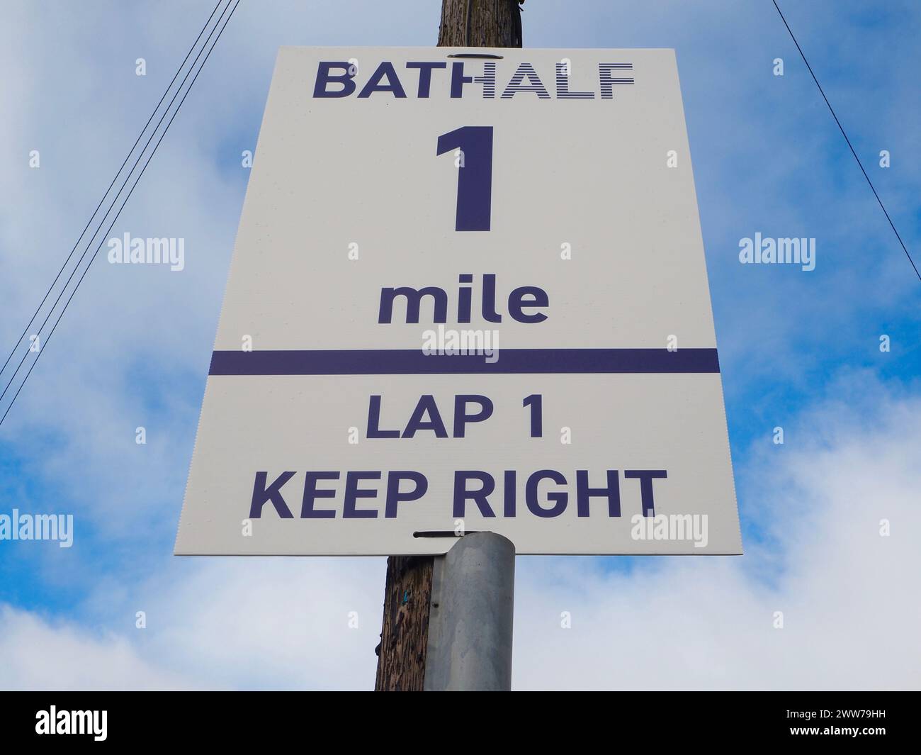 Bath Half Marathon one mile progress sign against cloudy blue sky ...