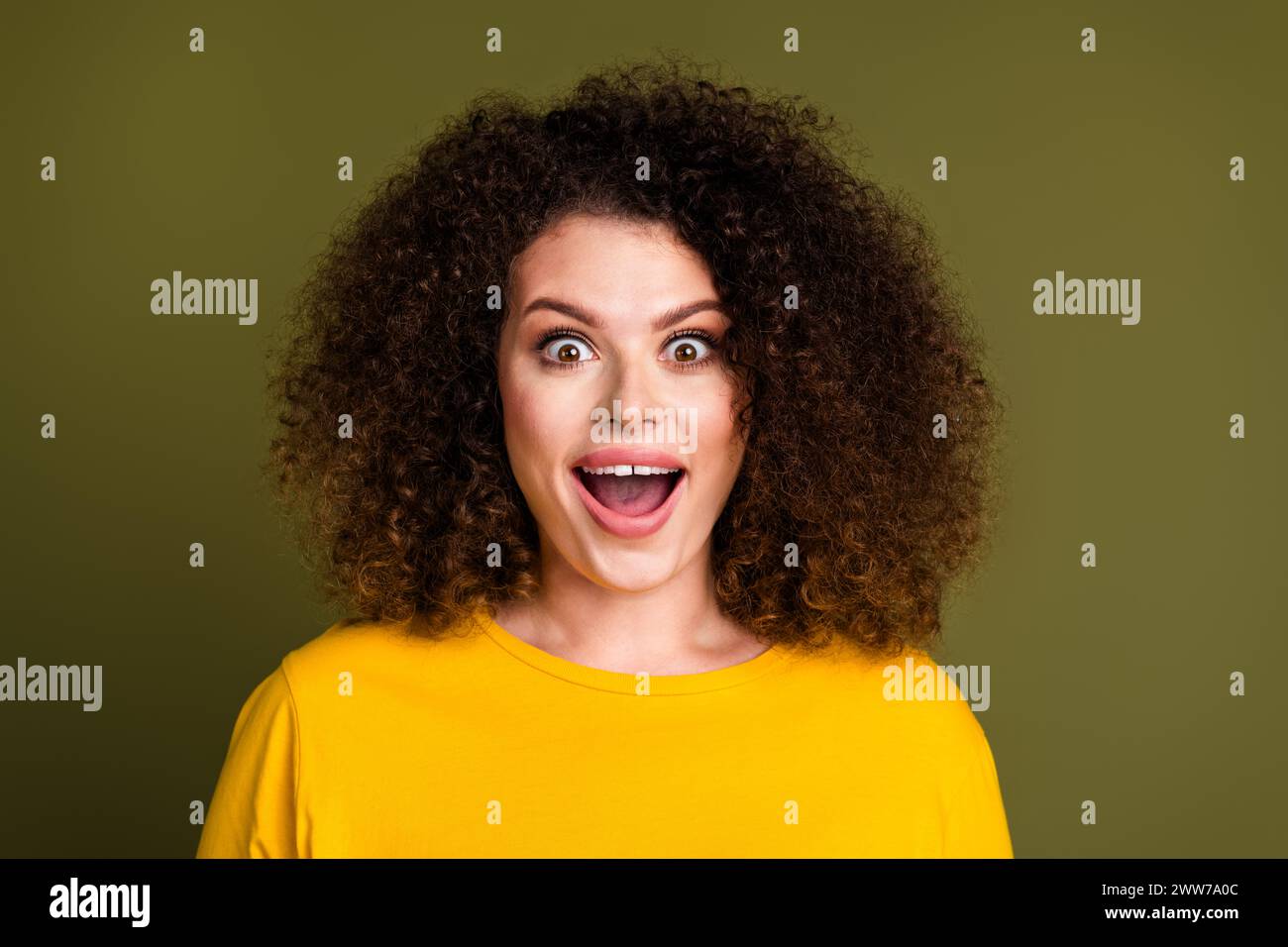 Portrait of young girl chevelure hair in yellow t shirt open mouth ...