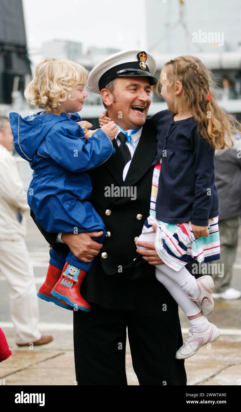 08/07/11.Pictured: PO Nigel Watts is welcomed home by his son and ...