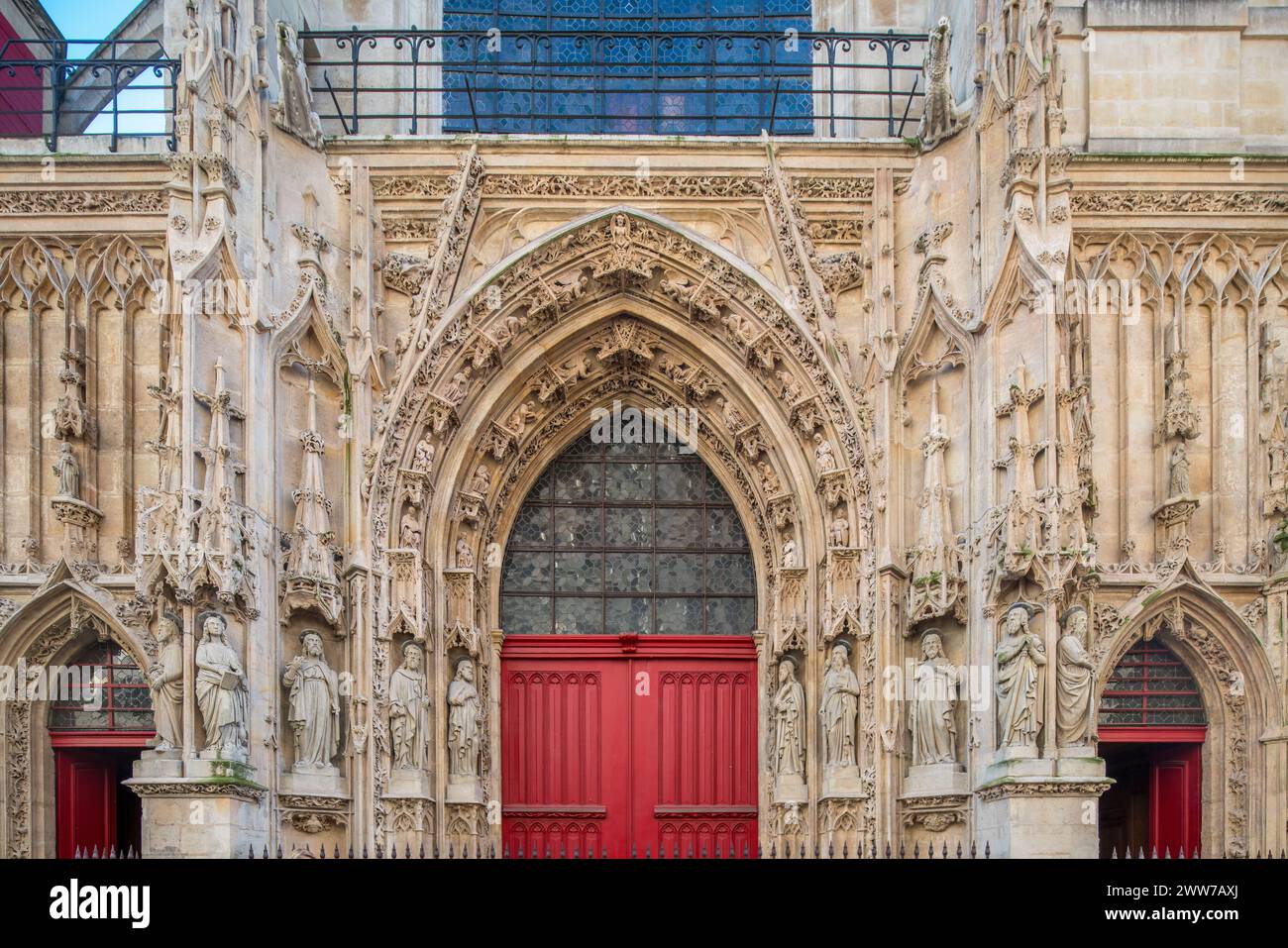 Intricate Gothic architecture and vibrant red doors of Saint Merri ...