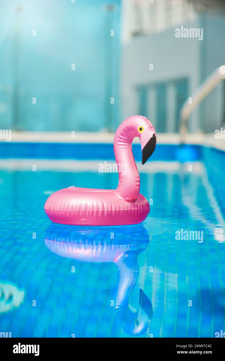 Pink pool float flamingo by blue water. Summer vacation holiday ...