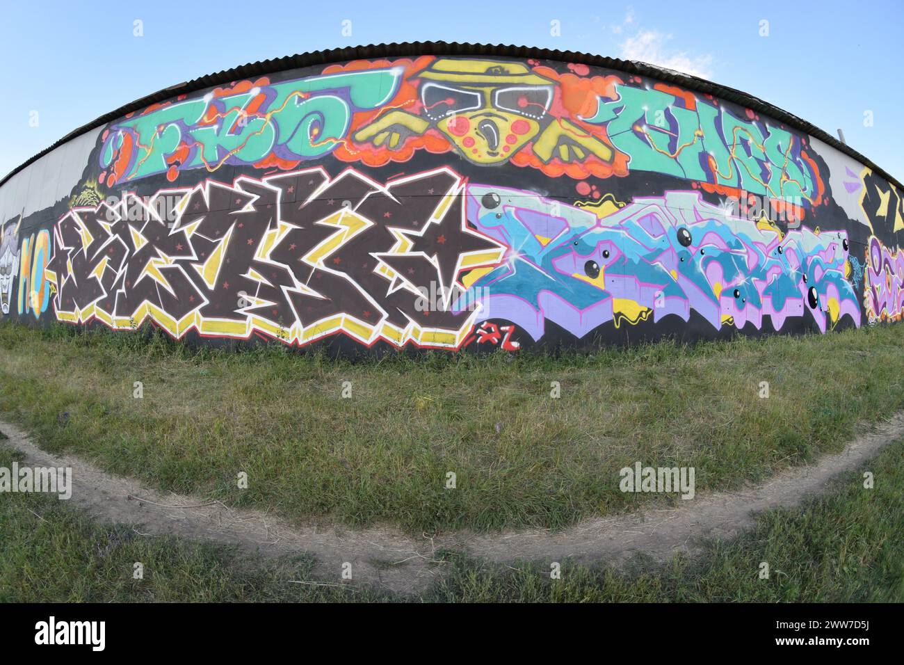 Fisheye shot of street art graffiti drawing on wall. Spray art artwork ...