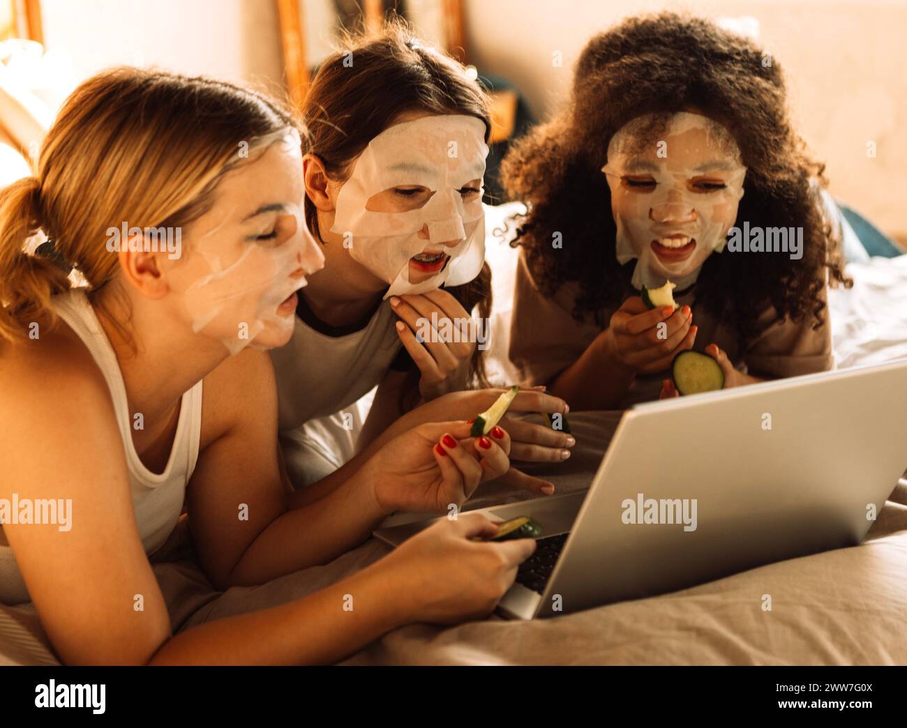 Charming mixed-race teenagers in cosmetic fabric masks on their faces ...