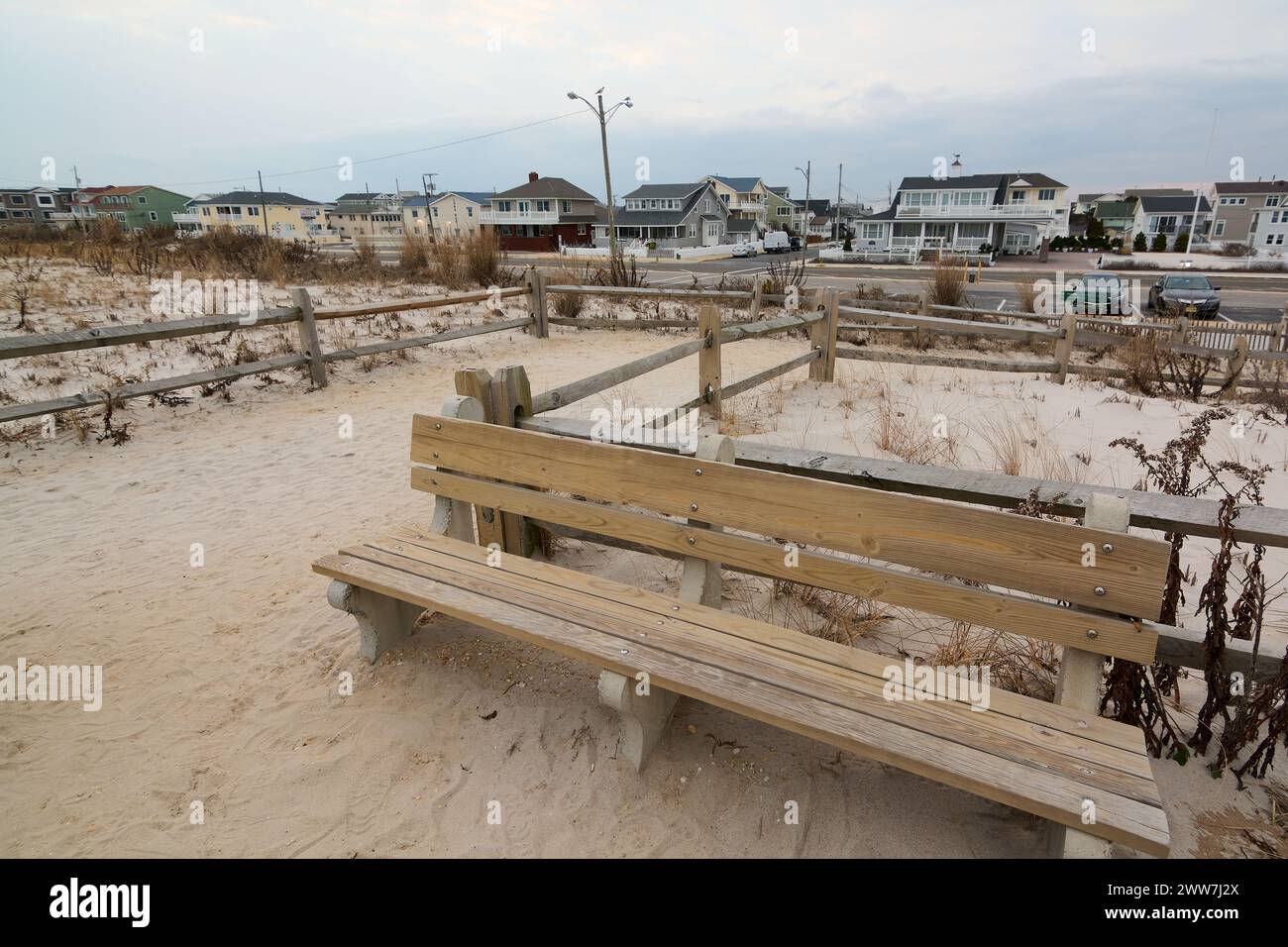 Coastal neighborhood with elegant houses, viewed through dunes ...