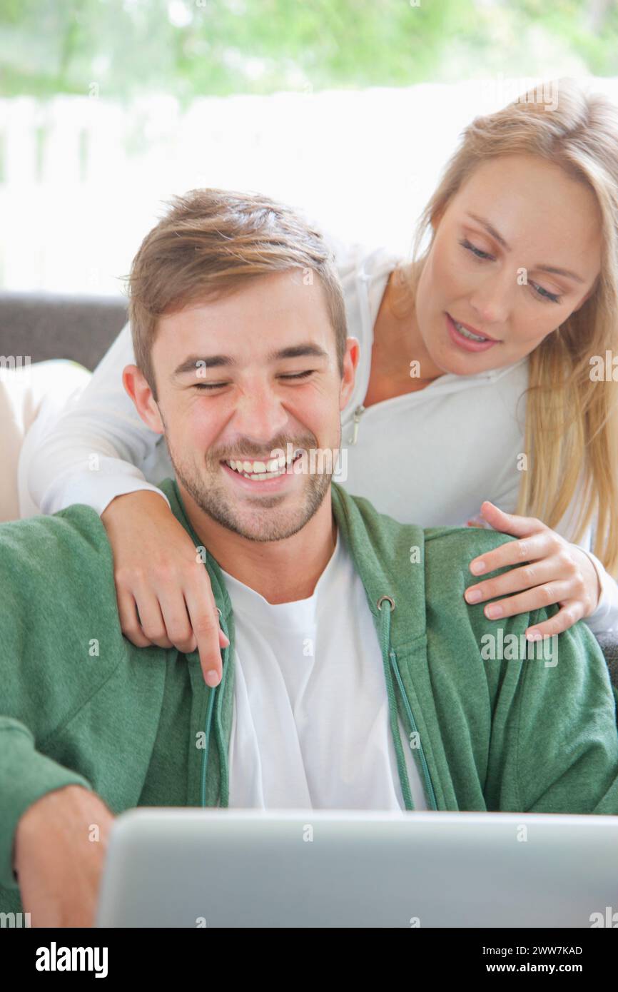 Couple on Sofa Using Laptop Stock Photo - Alamy