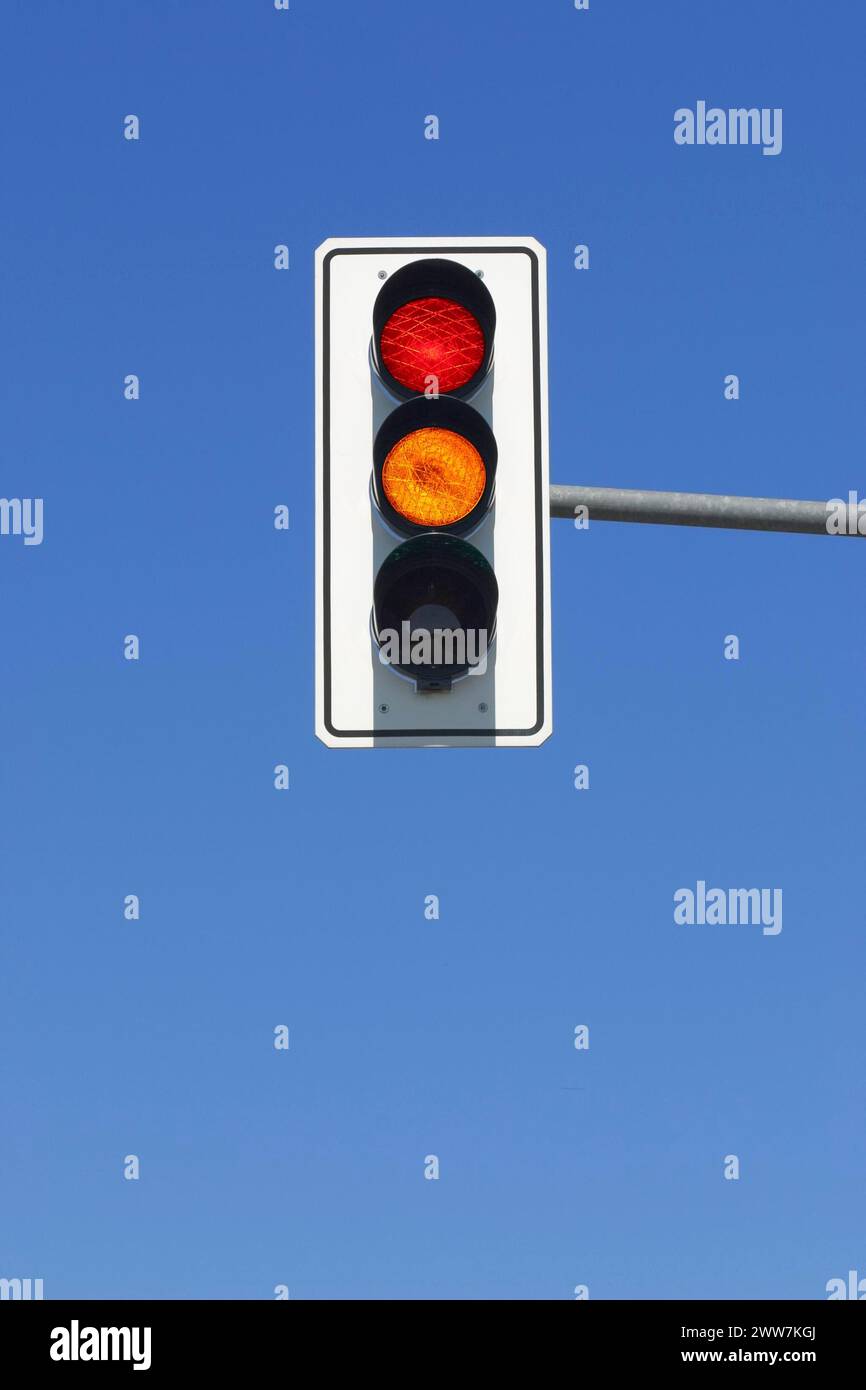 Red and yellow traffic light in blue sky Stock Photo - Alamy