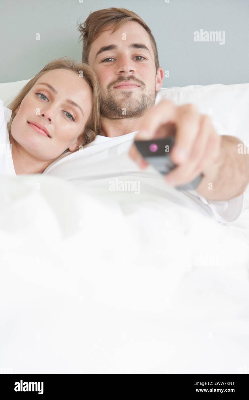 Couple cuddling watching tv hi-res stock photography and images - Alamy