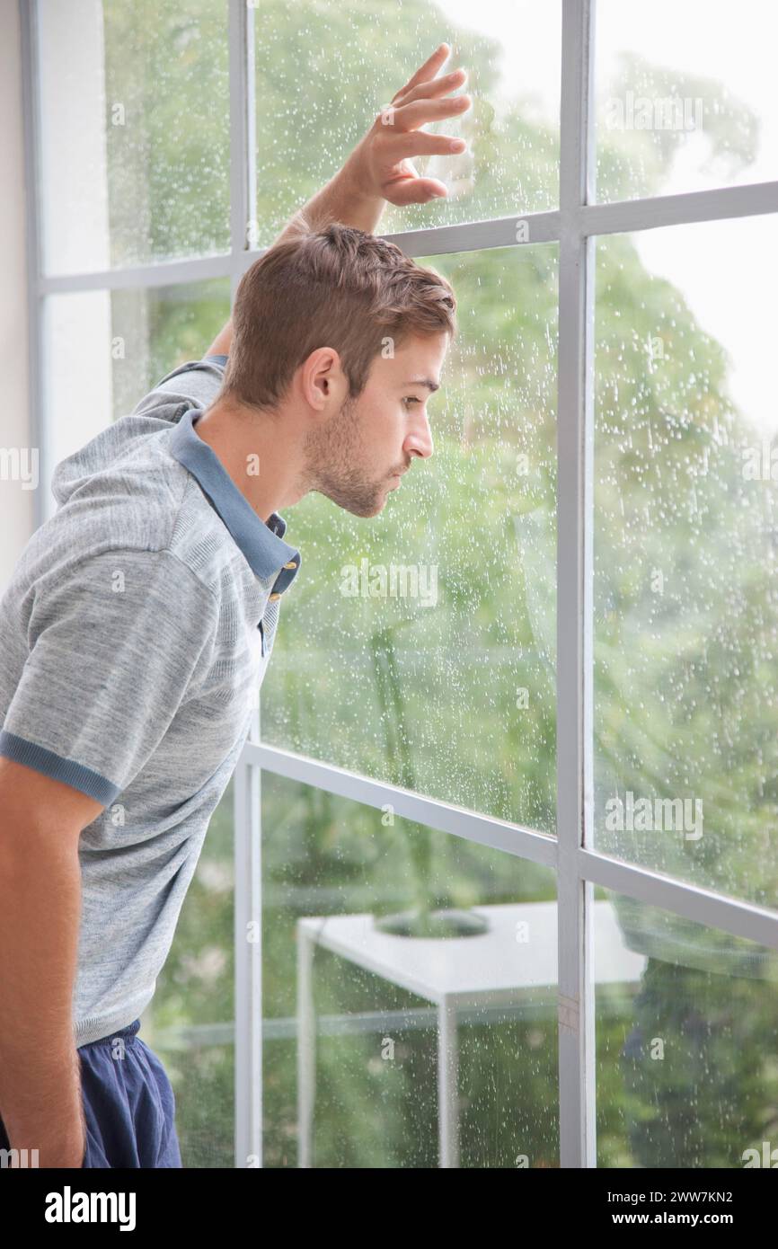 Man Looking out of Window Stock Photo - Alamy