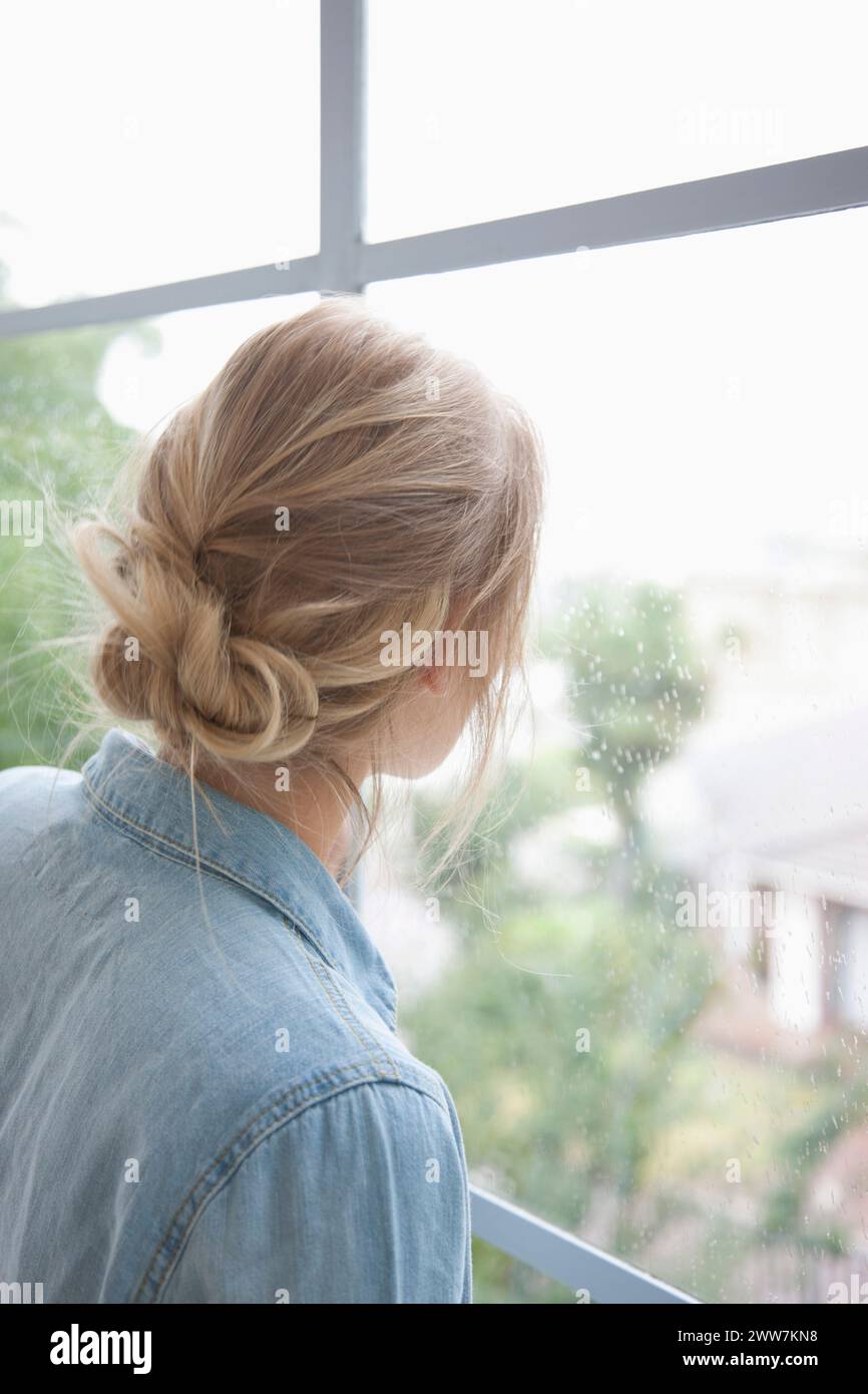 Back View of Woman Looking out of Window Stock Photo - Alamy