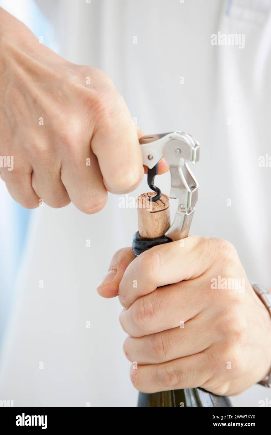 Man opening wine bottle corkscrew hi-res stock photography and images ...