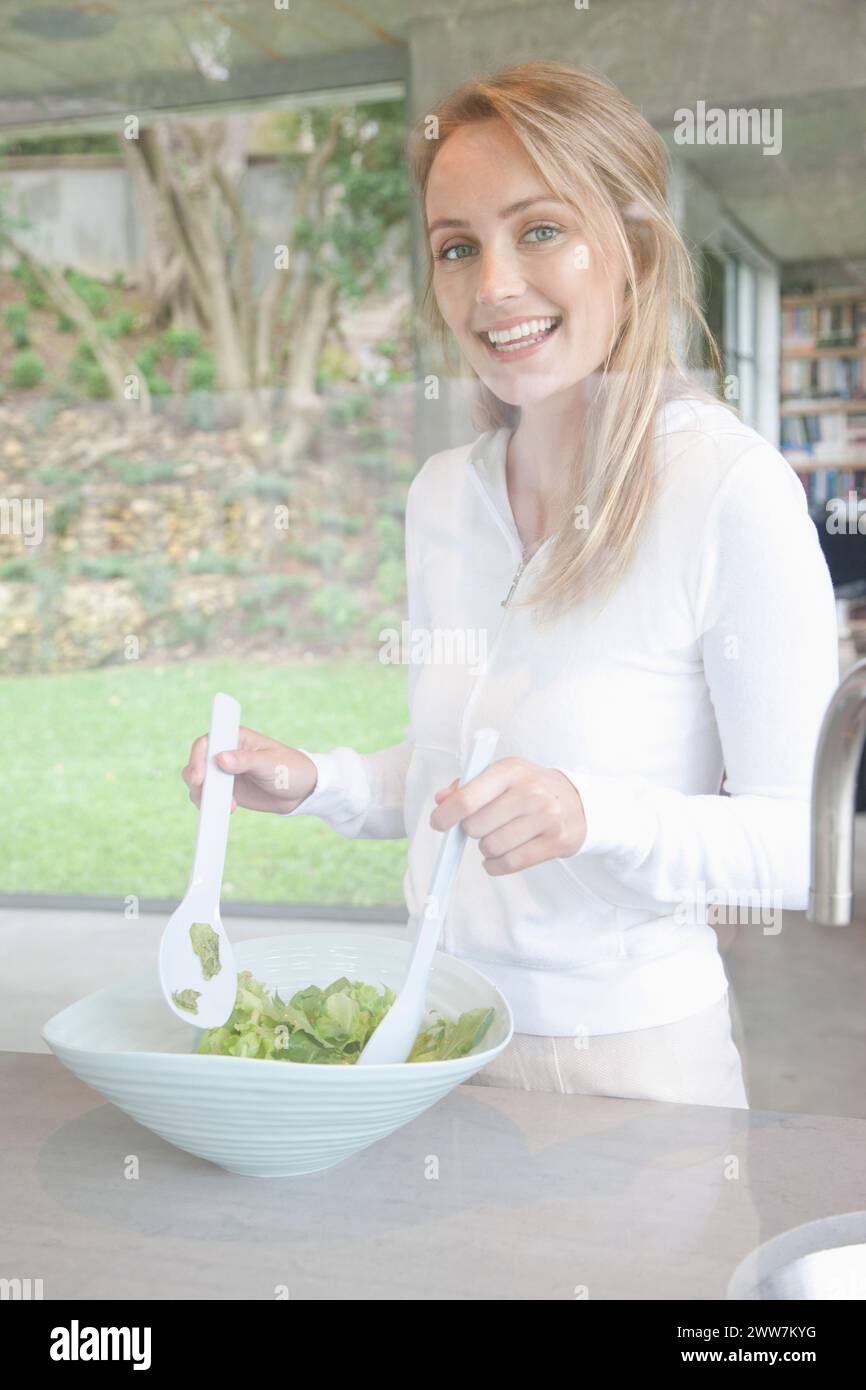 Woman tossing salad looking at camera hi-res stock photography and ...