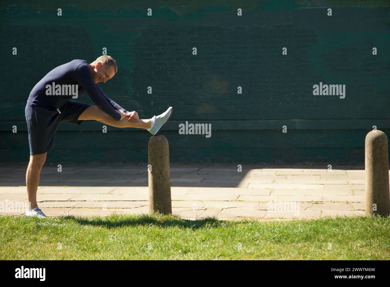 Senior man stretching legs hi-res stock photography and images - Alamy