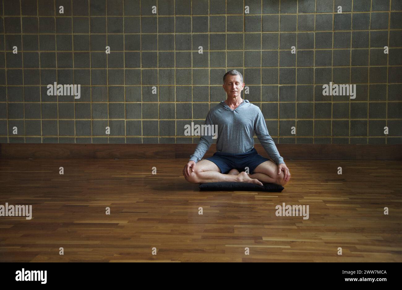 Mature Man Practicing Yoga, Easy pose Stock Photo - Alamy