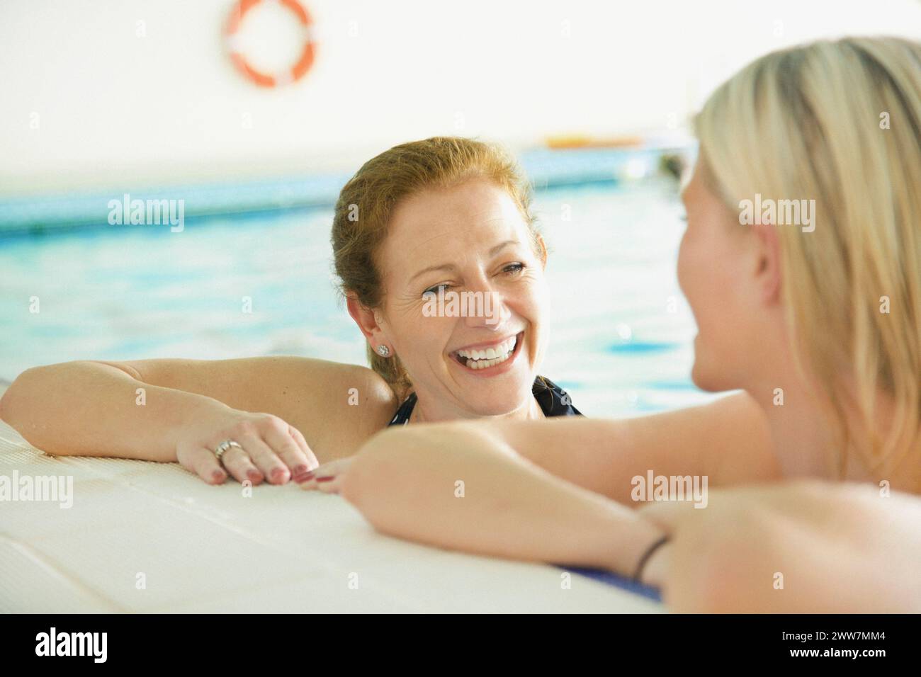 Two Women in Indoor Swimming Pool Smiling Stock Photo - Alamy
