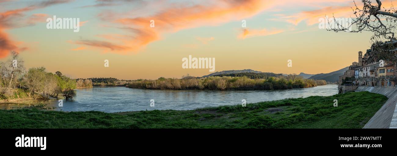 view of the Ebro River and the old town of Miravet, Spain, highlighting ...