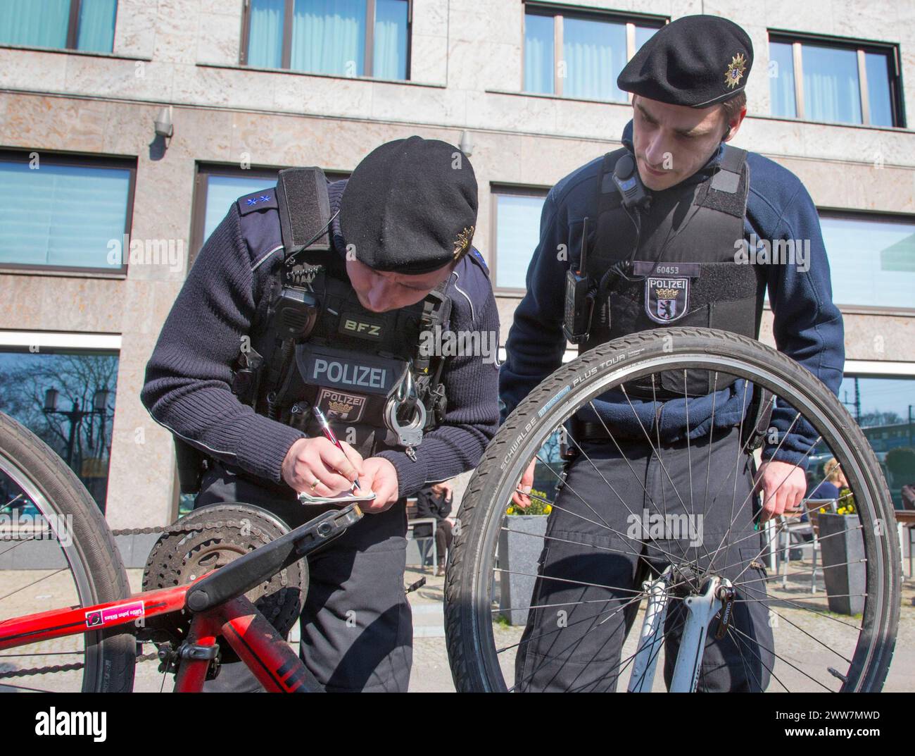 Berlin police officers check the chassis number of a bicycle during a ...