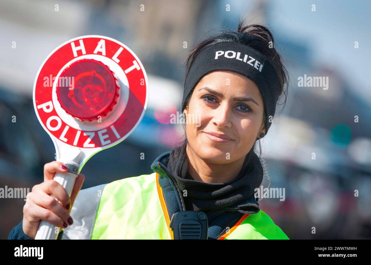Policewoman of the Berlin police with police trowel during a traffic ...