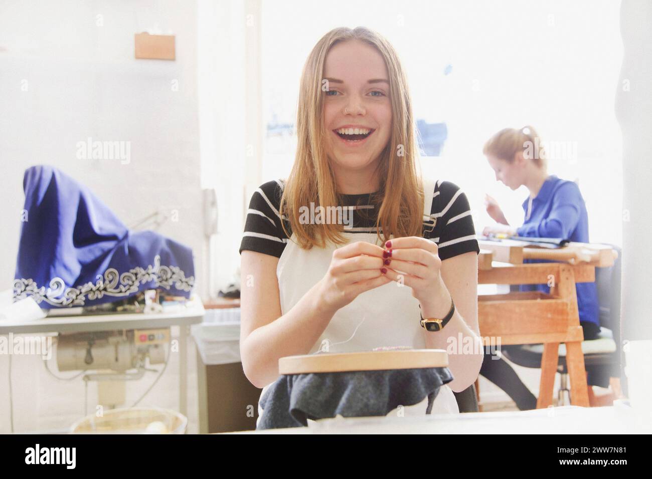 Smiling Female Employee at Embroidery Design Studio Stock Photo - Alamy